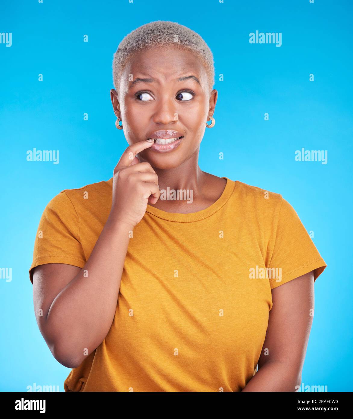 Black woman, biting nails and anxiety in studio with thinking, confused or ideas for decision by ...