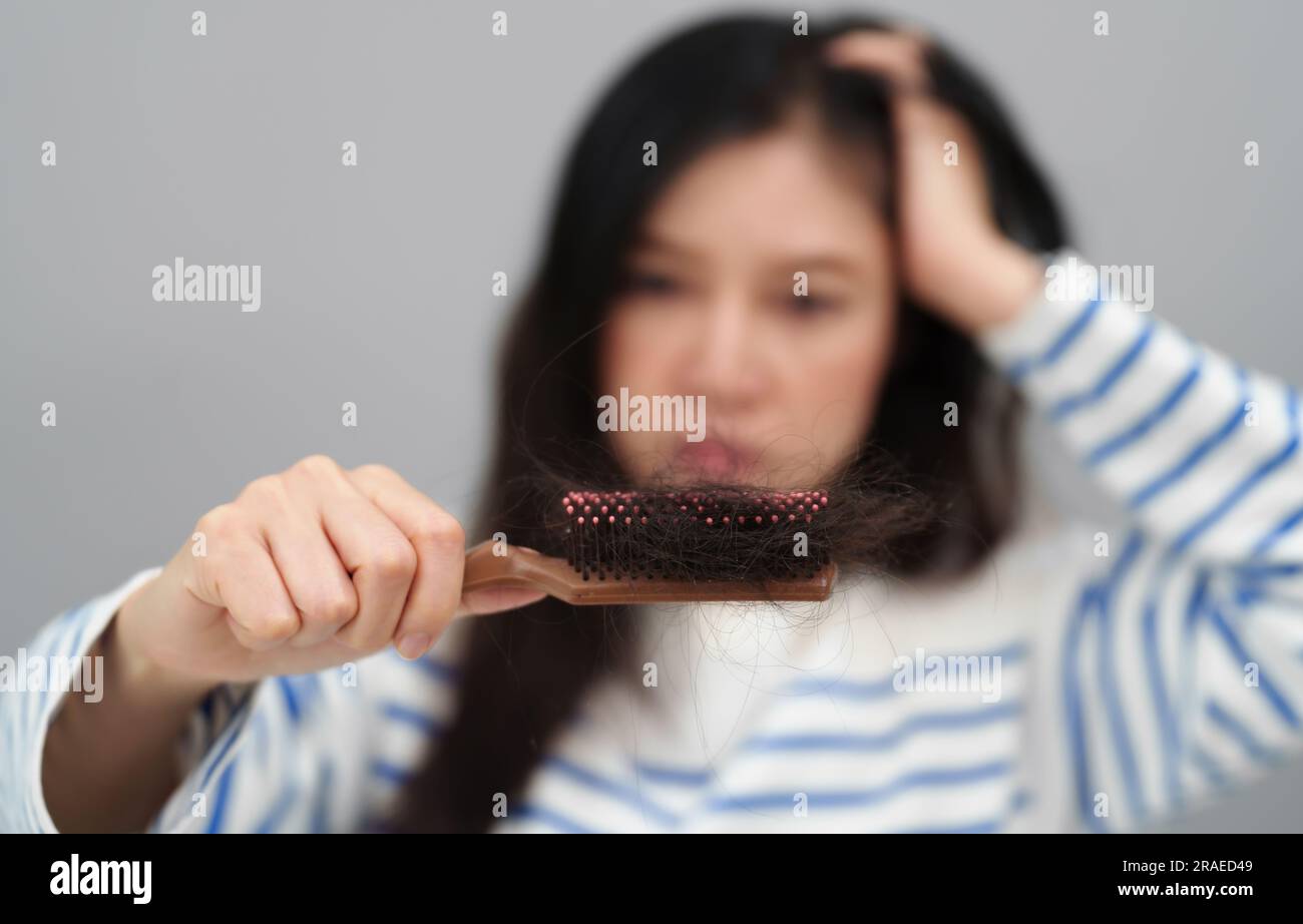 stressed woman having hair loss problem with her hairbrush Stock Photo ...