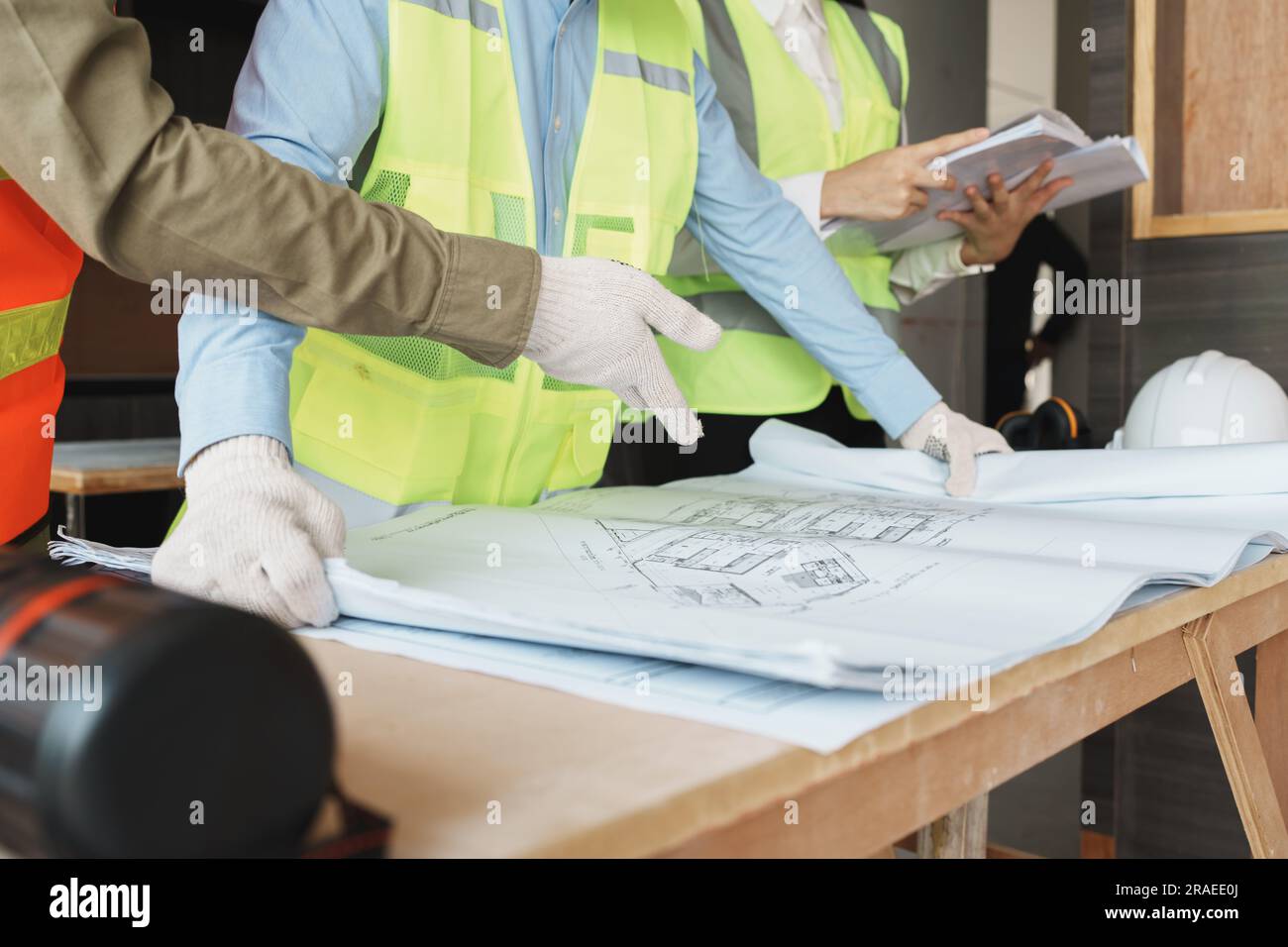 multi ethnic engineer brainstorming and measuring for cost estimating ...