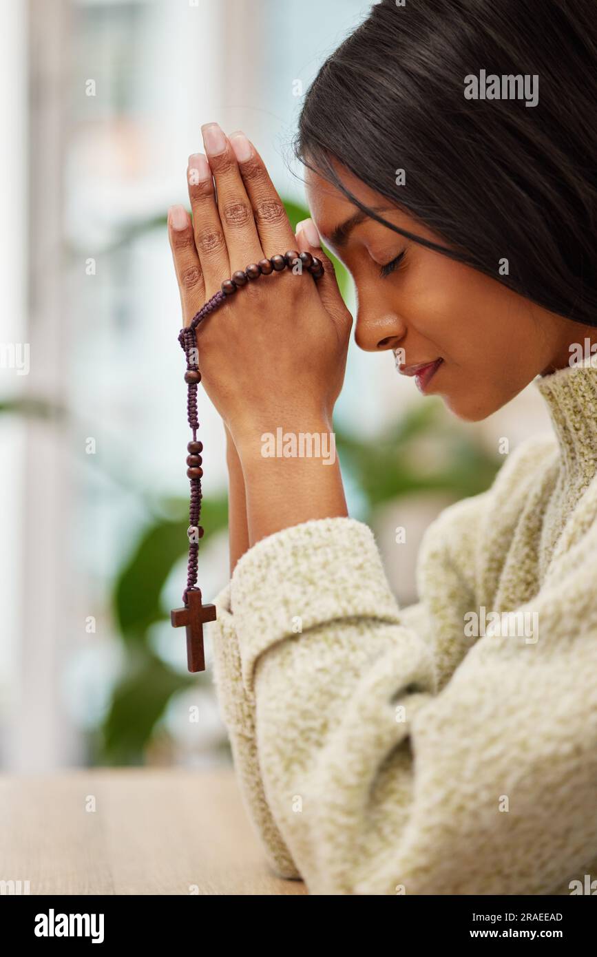 Praying, hands and Indian woman with a rosary in her home for worship, praise and gratitude to ...