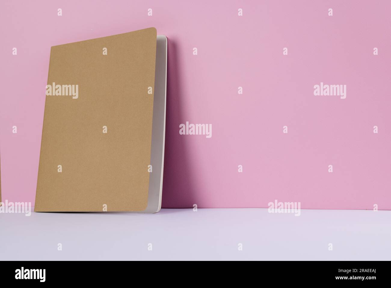 Close up of beige notebook with copy space on pink background Stock ...