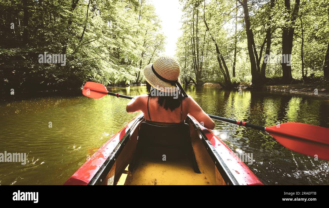 Back view Kayaking couple in river. POV of woman tandem kayaking in ...