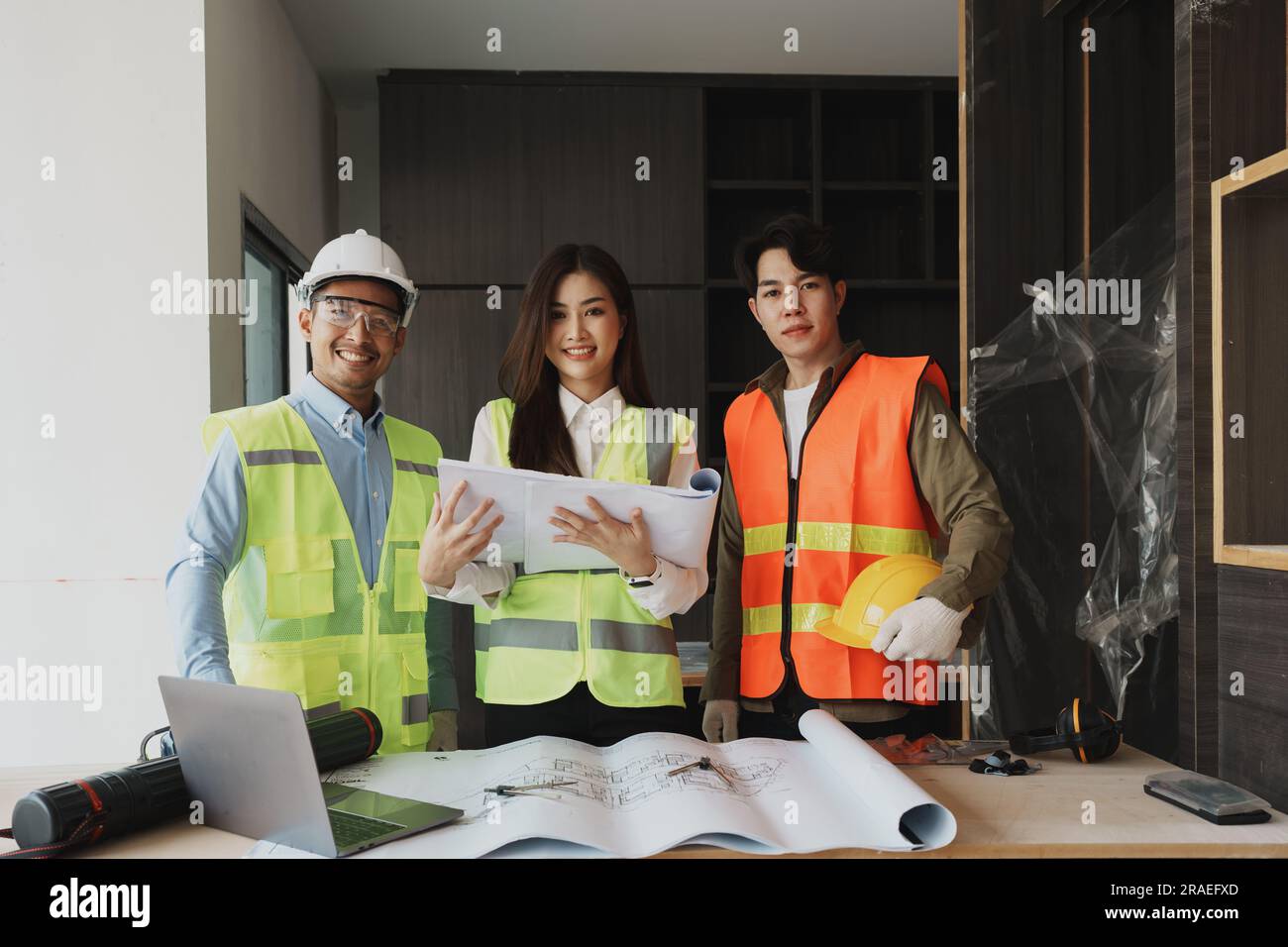 multi ethnic engineer brainstorming and measuring for cost estimating ...