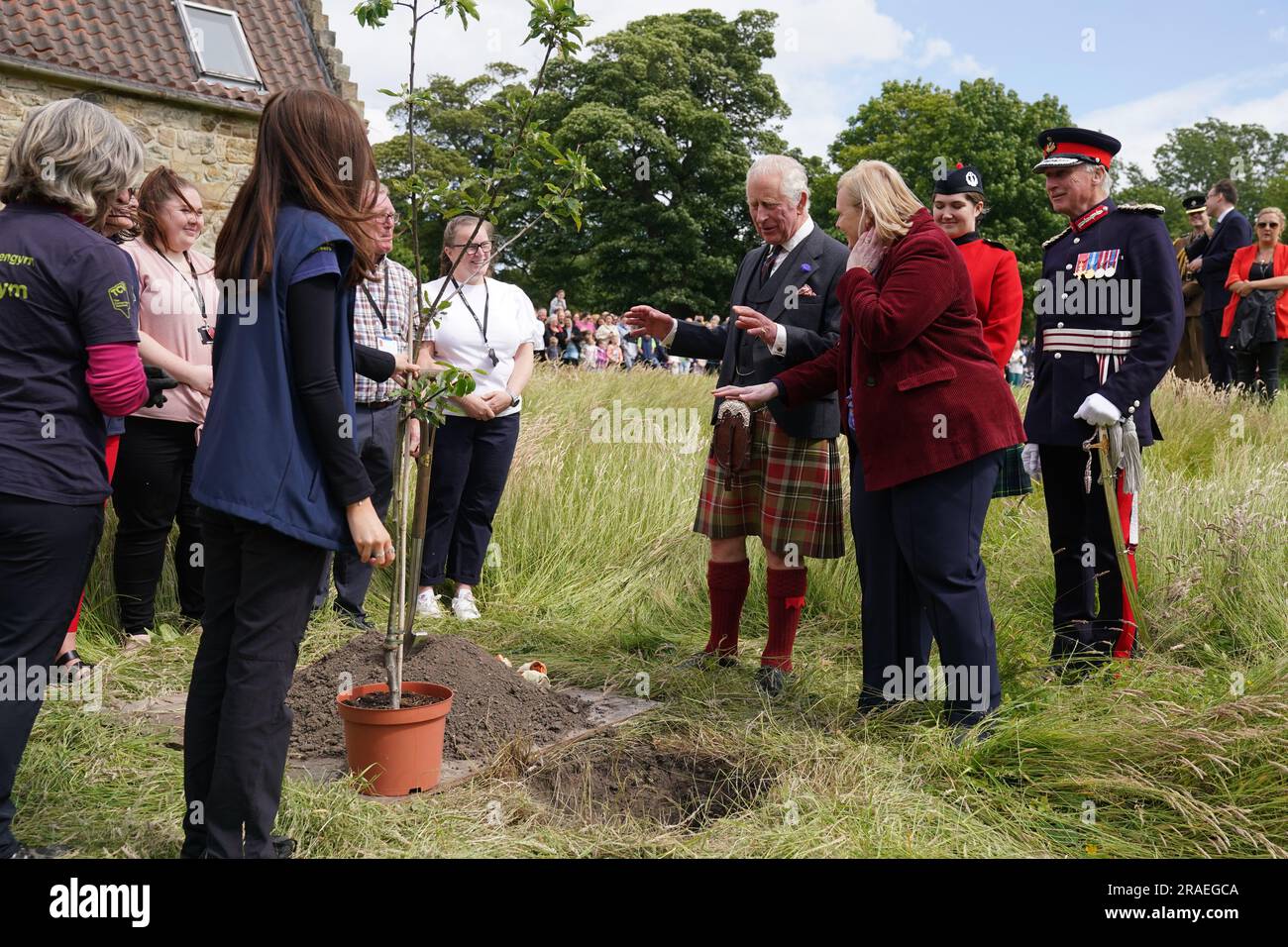 King Charles III (centre) plants a tree to commemorate the centenary of ...