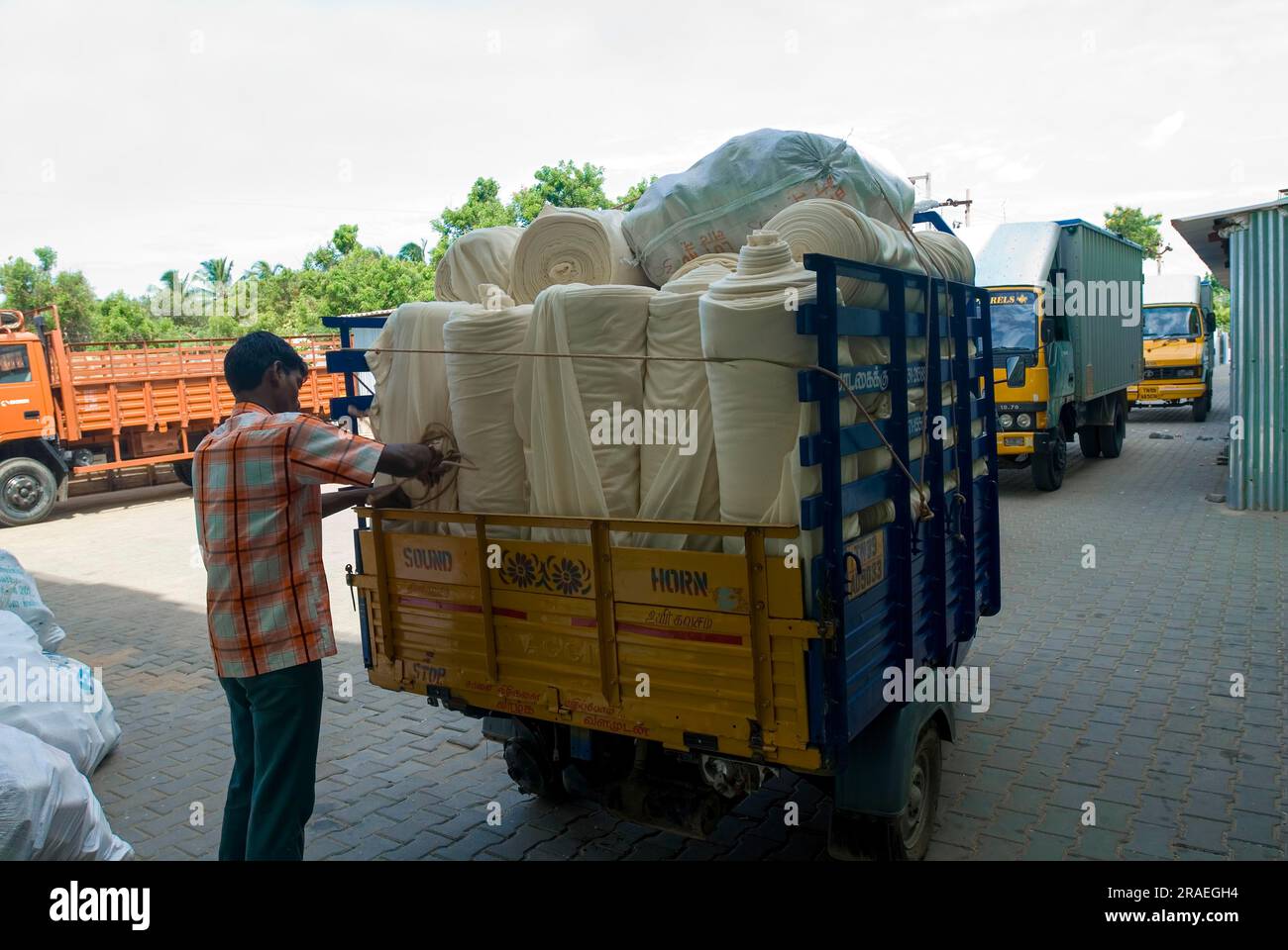 A man loading fabric, garment industry, Tiruppur Tirupur, Tamil Nadu ...