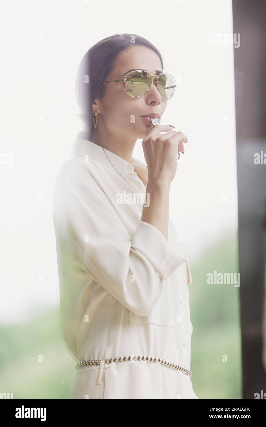 Portrait of attractive brunette holding whistle in her hand ...