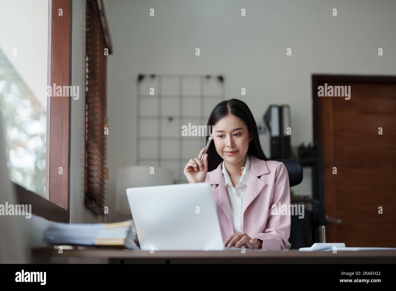 Young asian businesswoman manager, lawyer or company employee holding ...