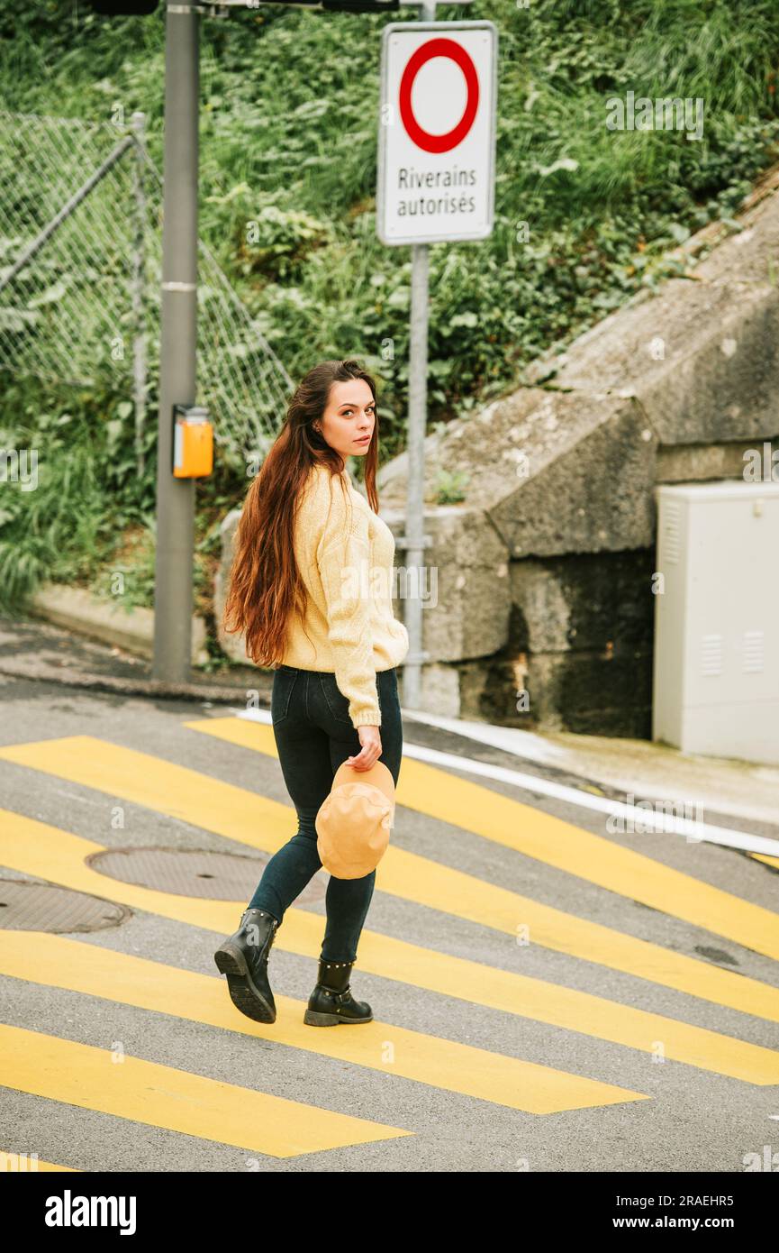 Outdoor portrait of beautiful young woman crossing road Stock Photo - Alamy