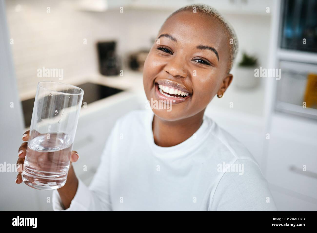 Portrait, glass and black woman drinking water, smile and health with joy, nutrition and ...