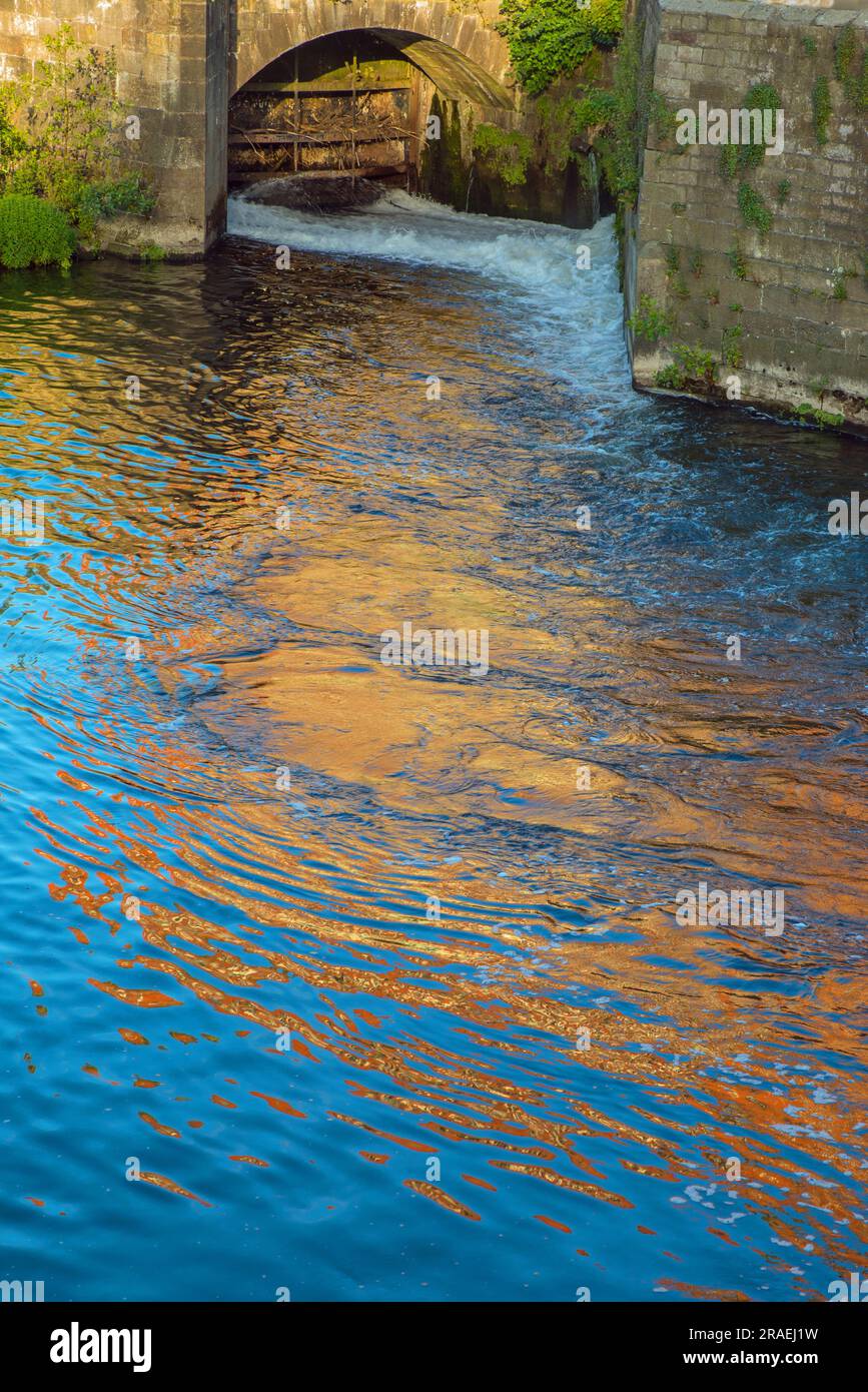 Orange reflections of a red brick building (Belper East Mill) in the ...