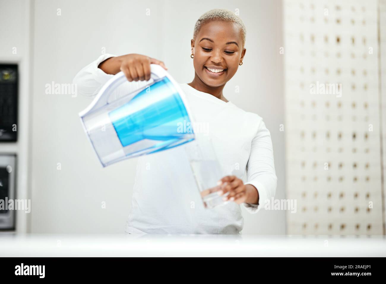 Black woman, pitcher and glass with water filter for clean and fresh ...