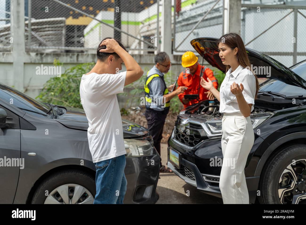An unset young woman talking angryly to a man who accidentally drove ...