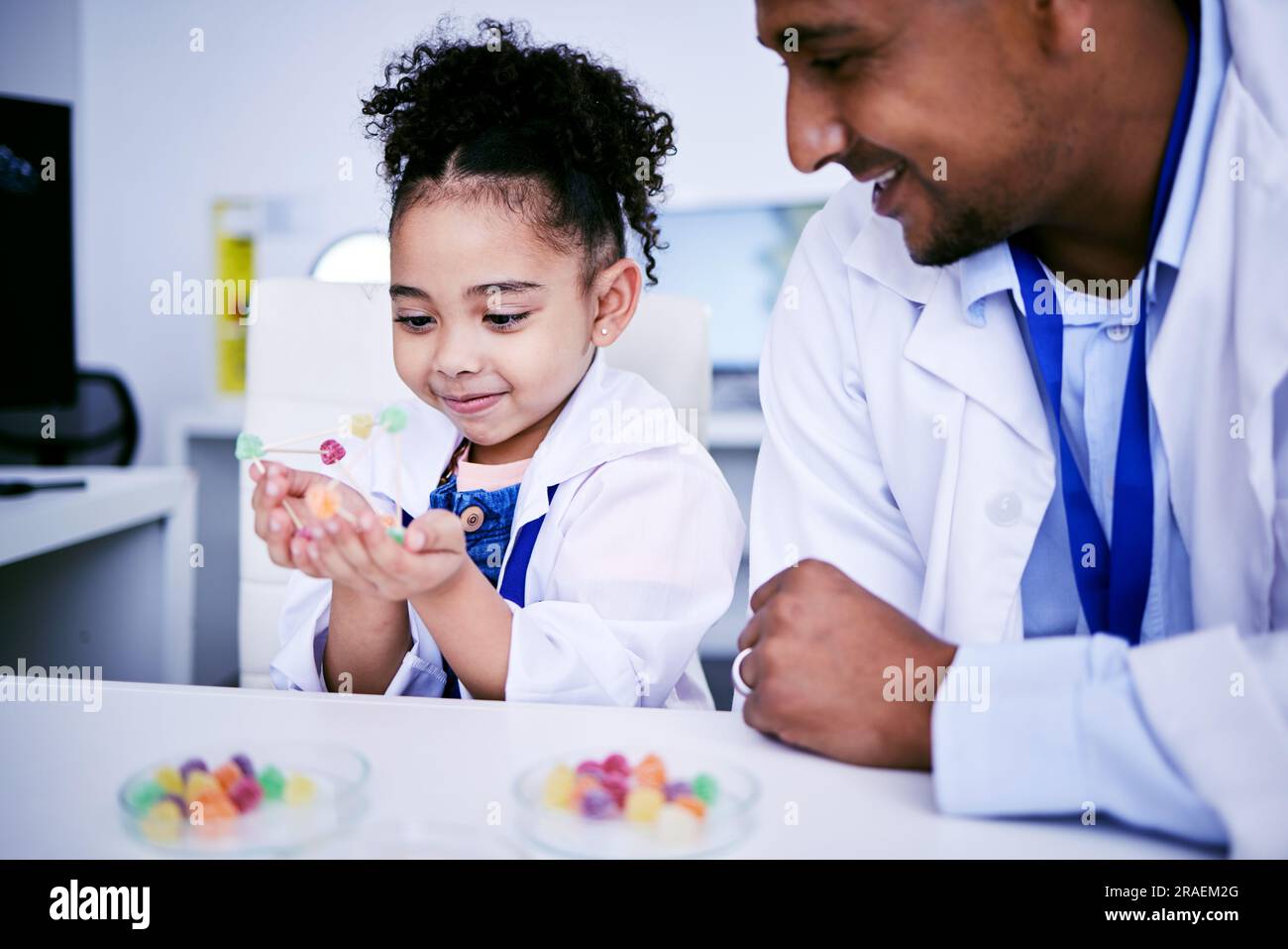 Science, research and child with her father in the lab working on an ...