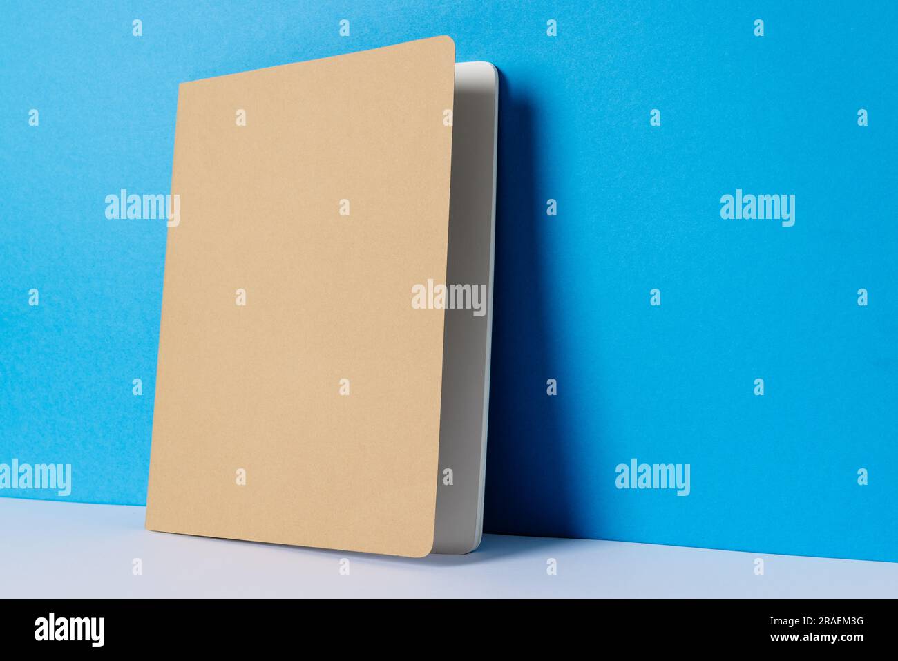 Close up of beige notebook with copy space on blue background Stock ...