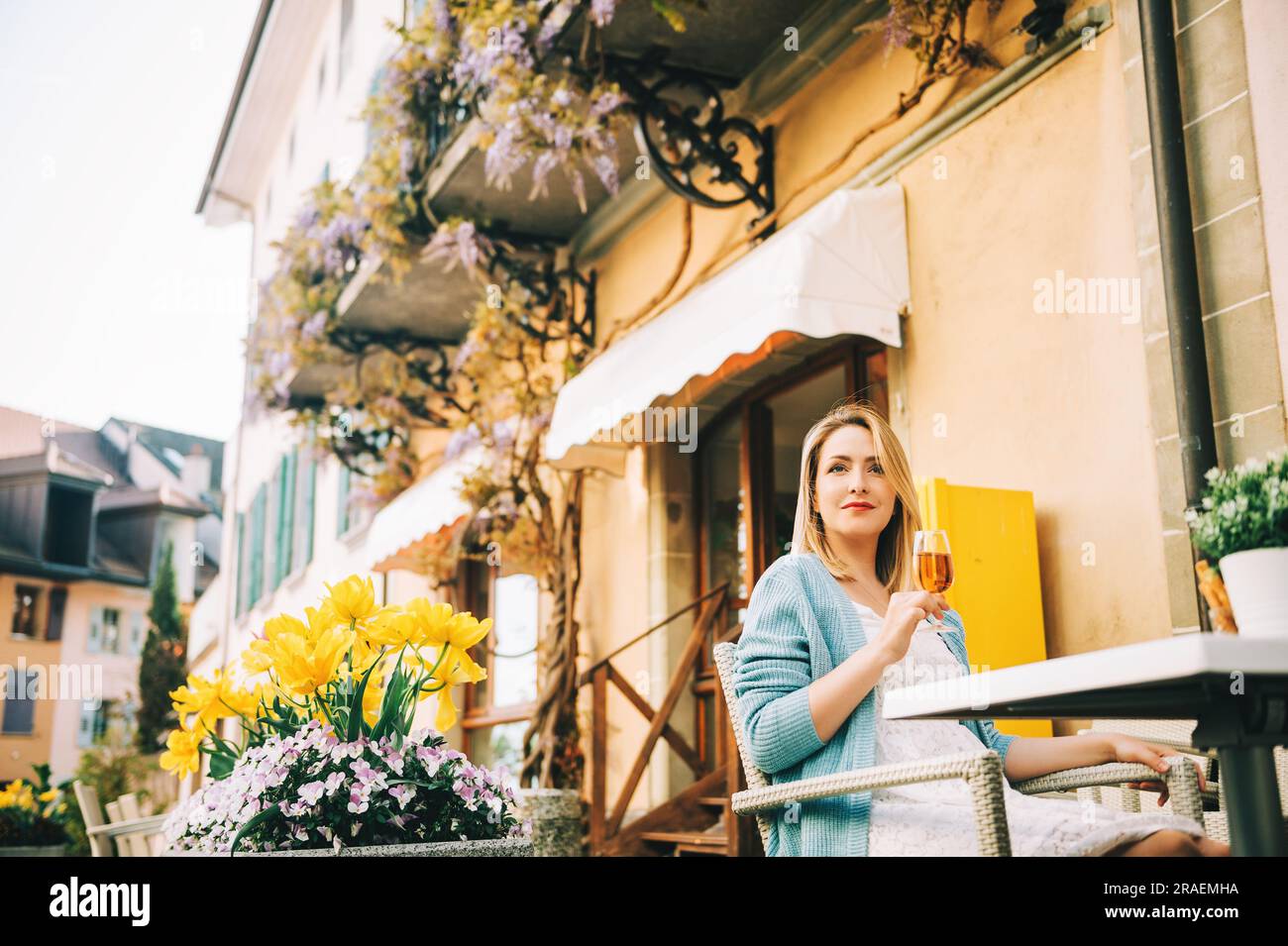 Outdoor portrait of pretty young woman resting in beautiful cafe on a ...