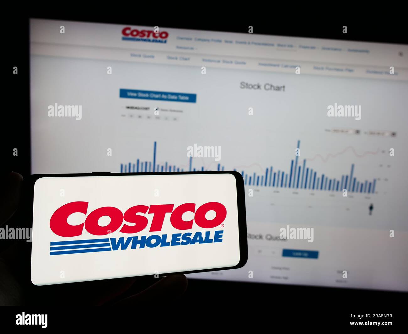 Person holding mobile phone with logo of American company Costco ...