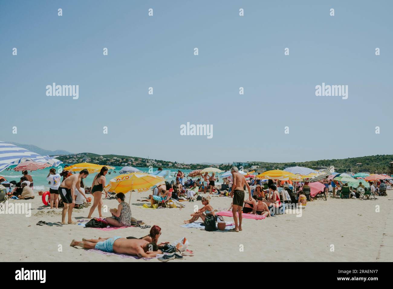 Izmir, Turkey. 30th June, 2023. People sunbathing at the beach. With ...