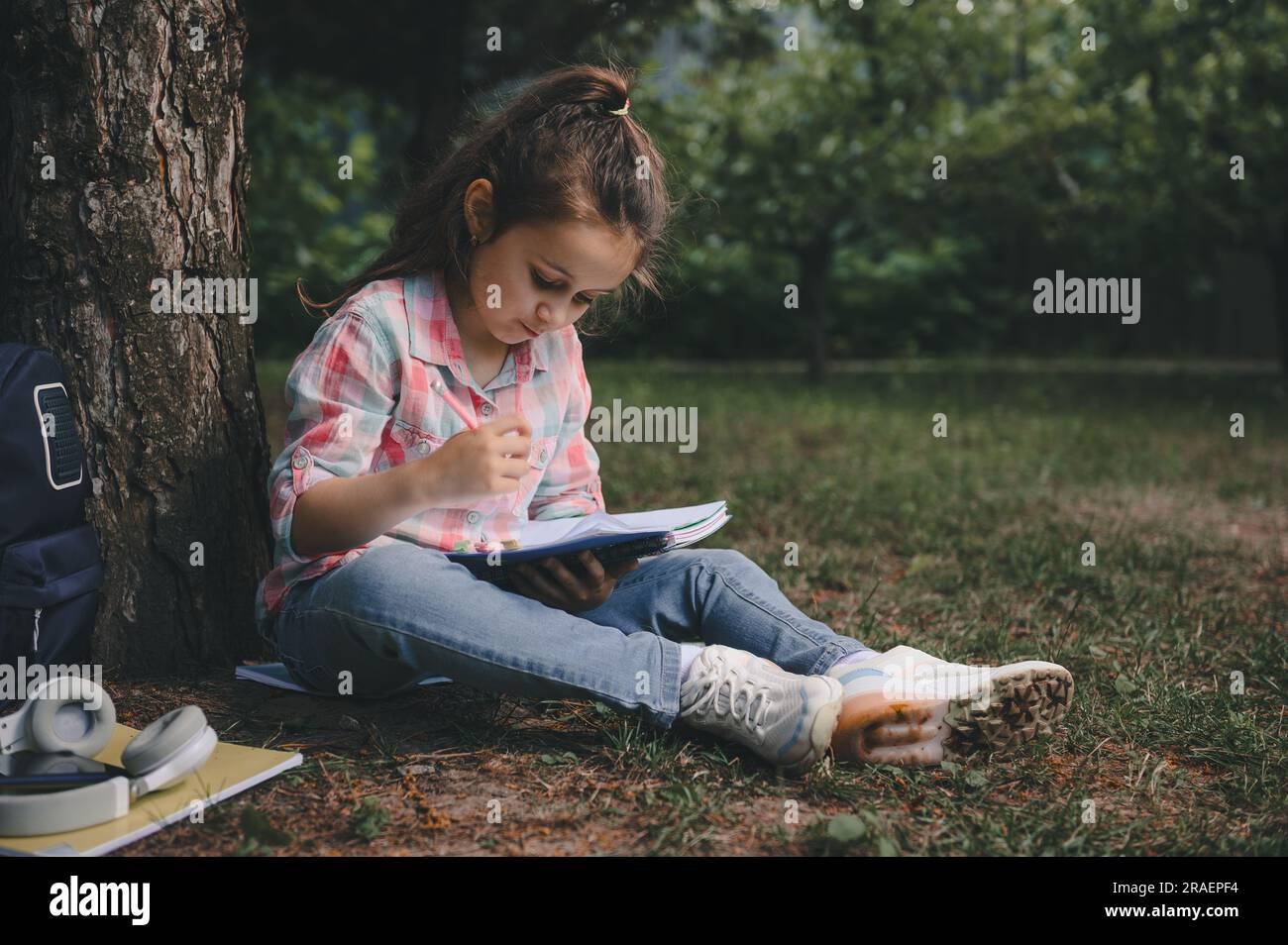 Cute little child girl, smart primary school student, first grader ...