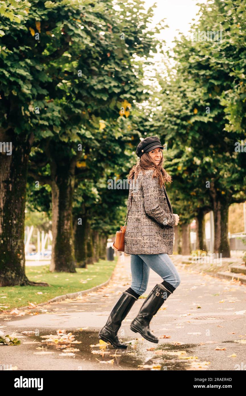 Outdoor full body fashion portrait of young beautiful fashionable woman ...