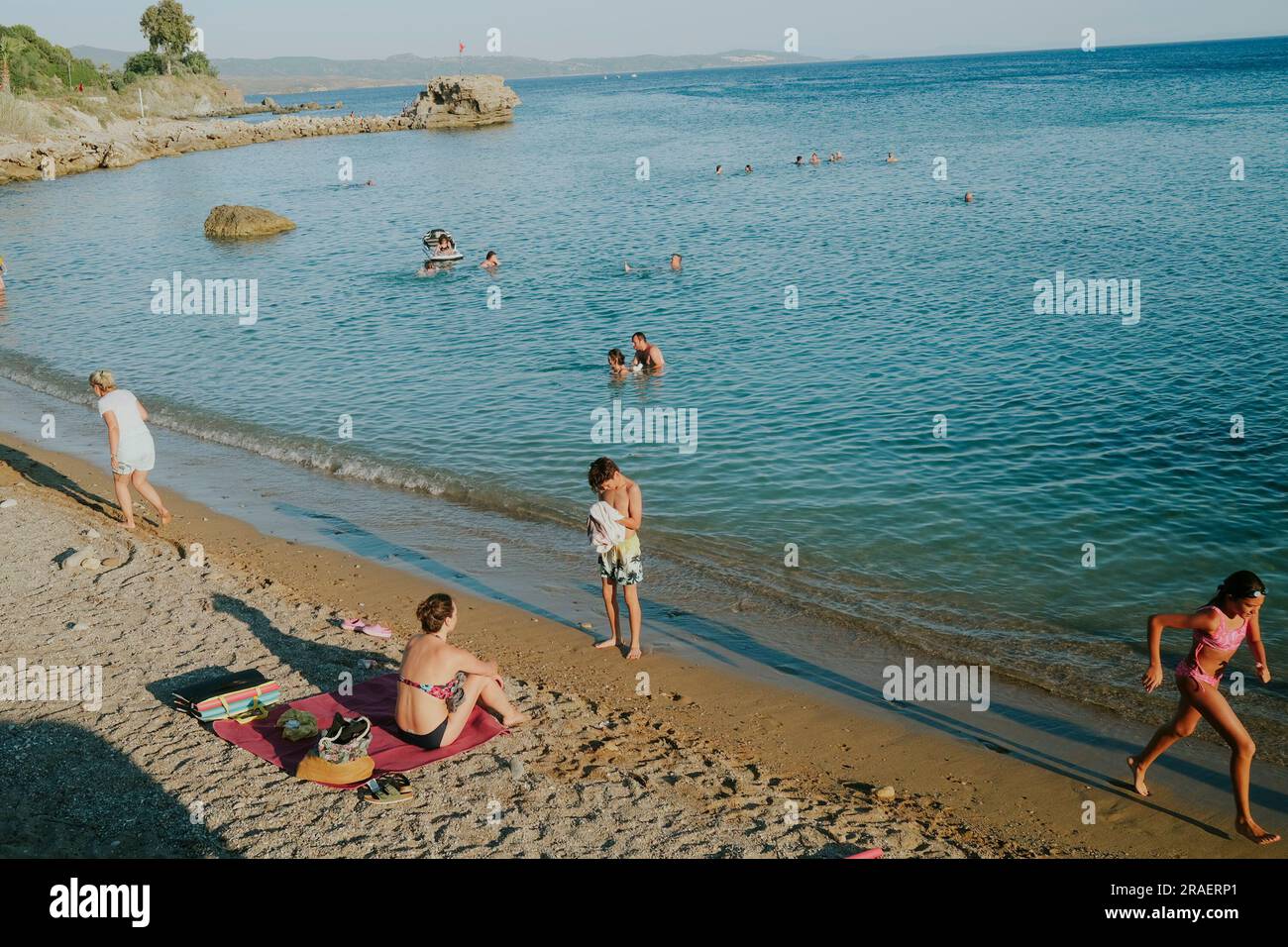 Izmir, Turkey. 30th June, 2023. People are sitting at the beach. With ...