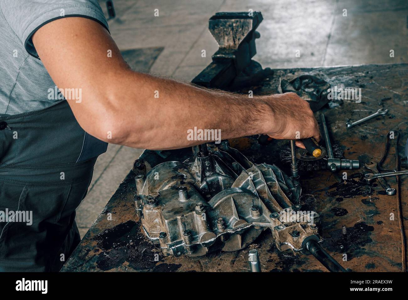 Mechanic repairs gearbox on metal workbench in car repair shop. Auto ...