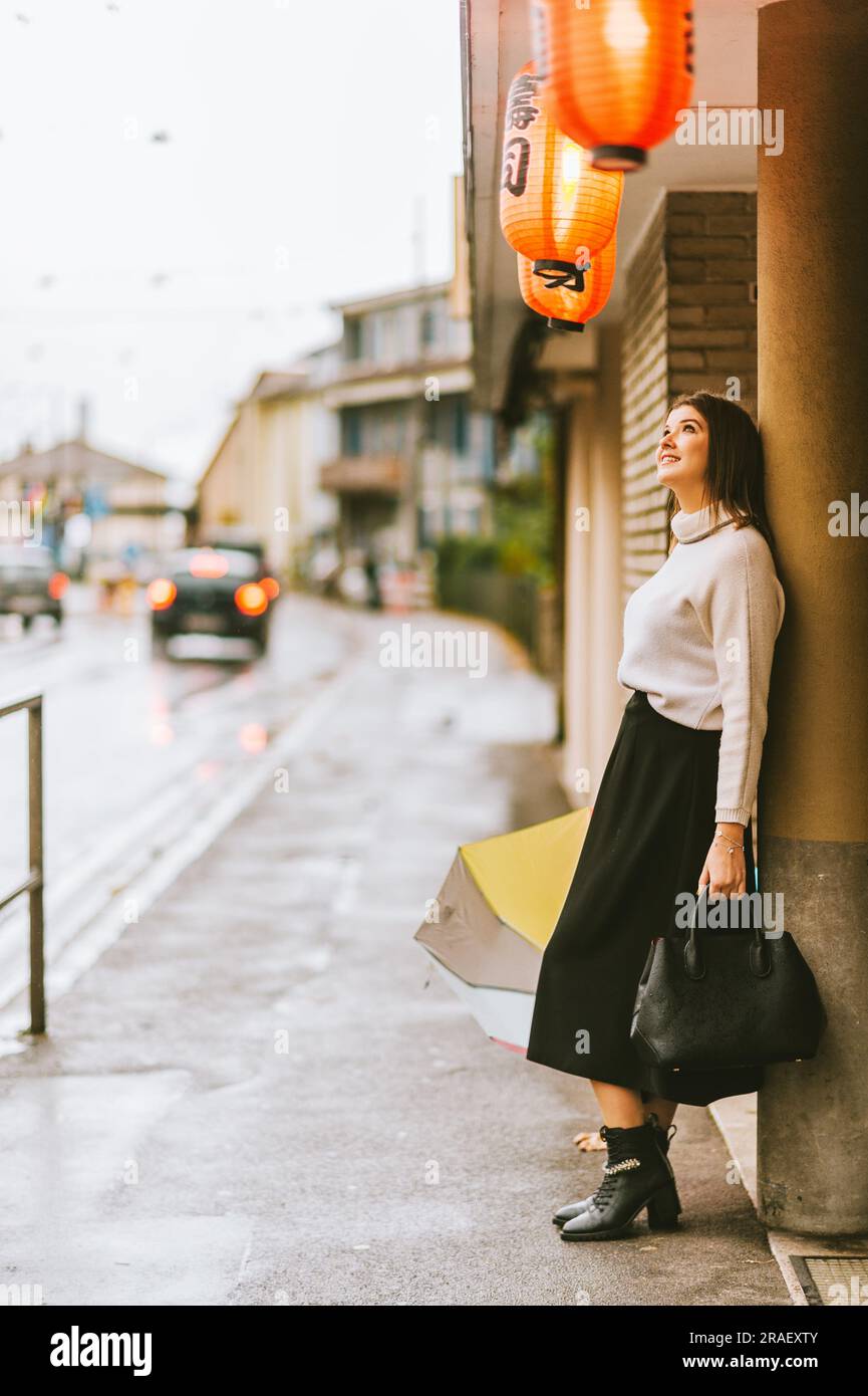 Outdoor street style portrait of young fashion woman, wearing warm ...