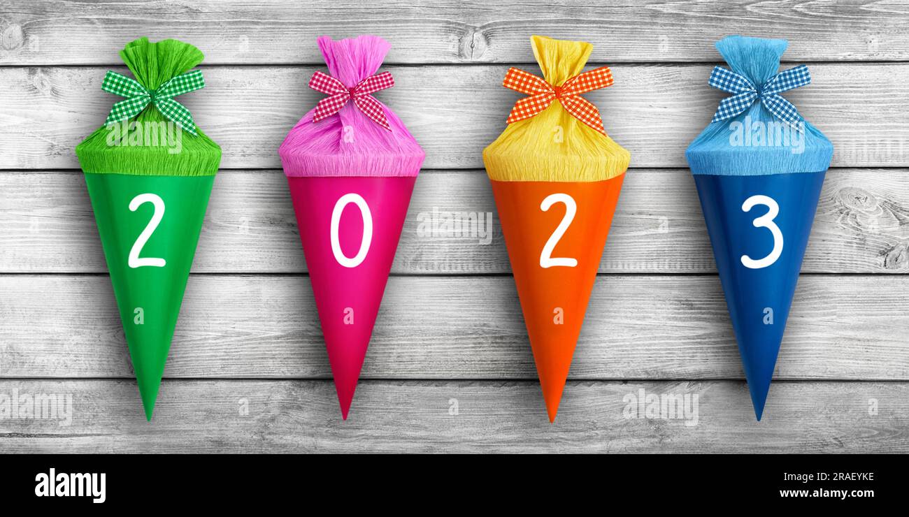 4 Cornets and presents 2023 with ribbon against wooden background Stock ...