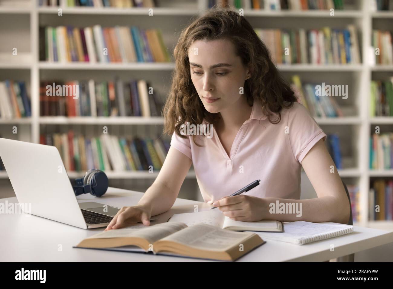 Serious focused pretty student girl studying in campus library Stock ...
