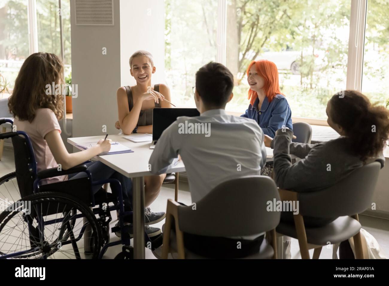 Team of students inclusively girl with disability meeting in campus ...
