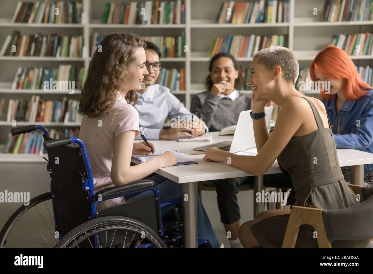 Young student with disability cooperating on project with college ...