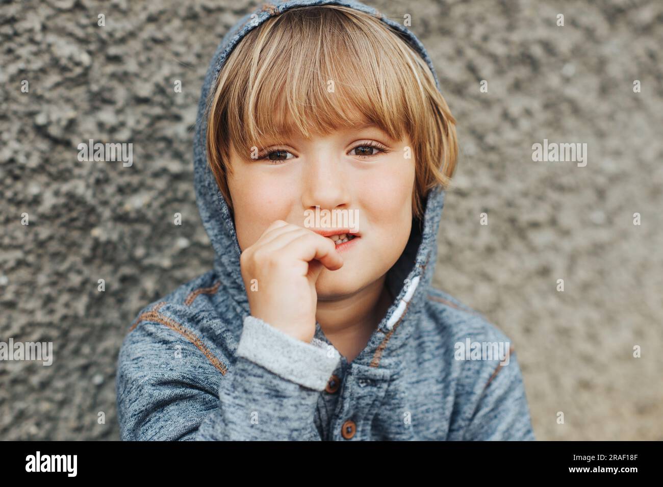 Stressed child biting finger nails, sad toddler boy Stock Photo - Alamy