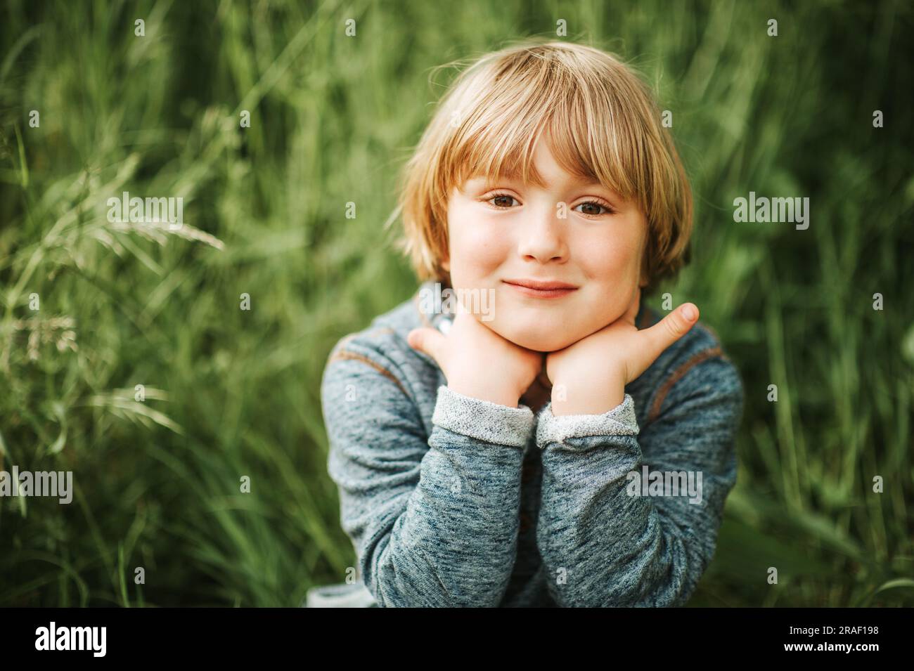 Candid portrait of adorable little boy of 4-5 years old, wearing blue ...