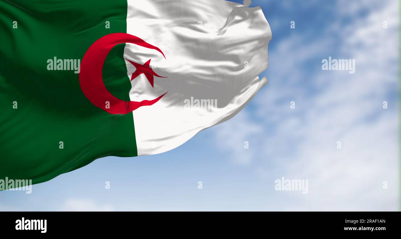 The national flag of Algeria waving in the wind on a clear day. two ...