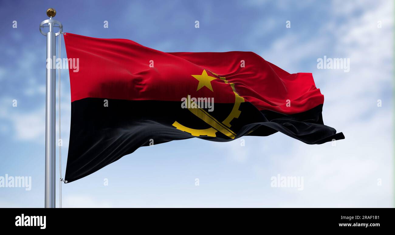 The national flag of Angola waving in the wind on a clear day. Two ...