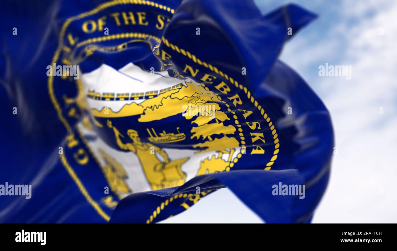 Close-up of the Nebraska state flag fluttering. The flag of is blue ...