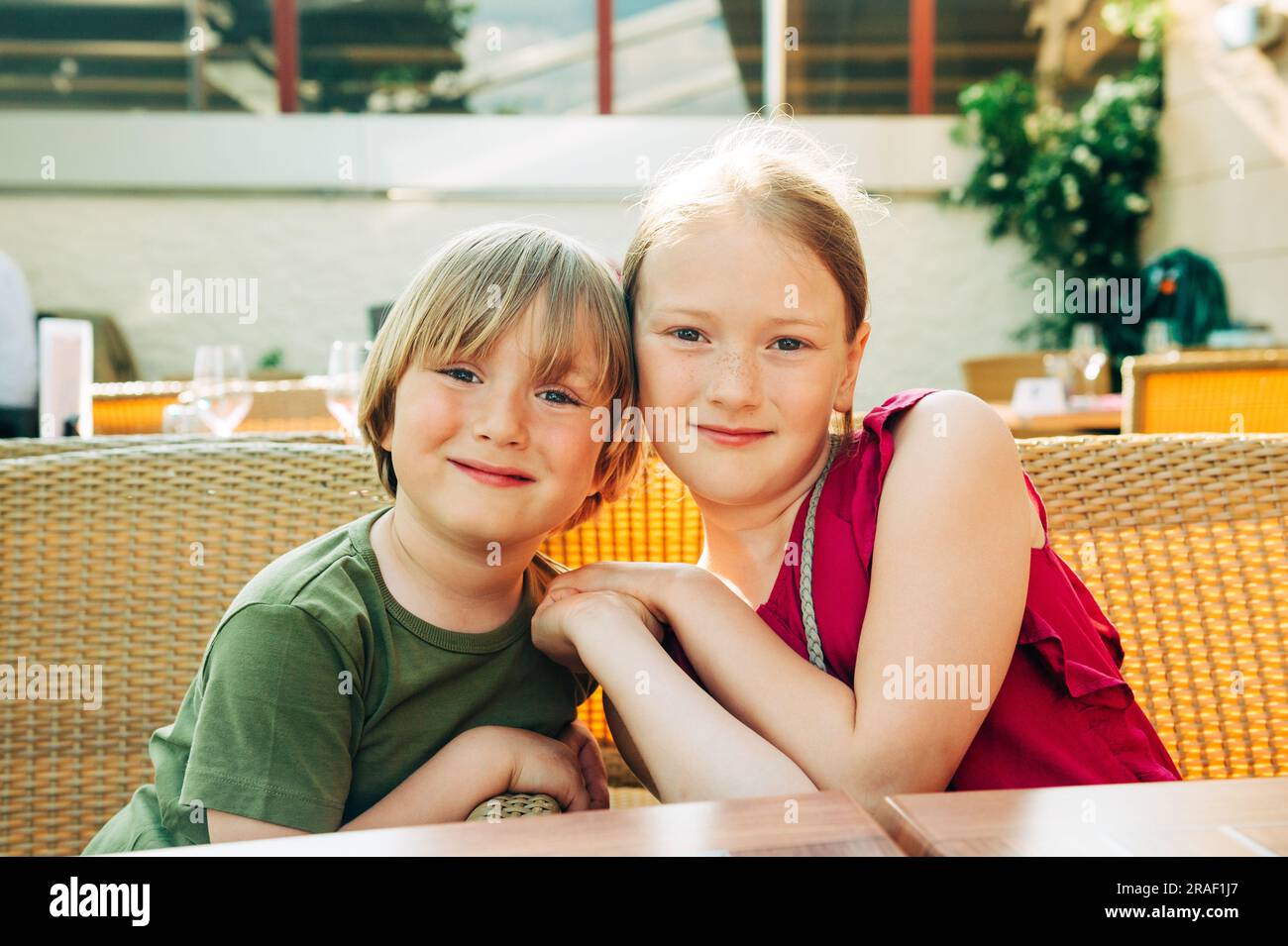 Outdoor summer portrait of two funny kids, small brother and big sister ...