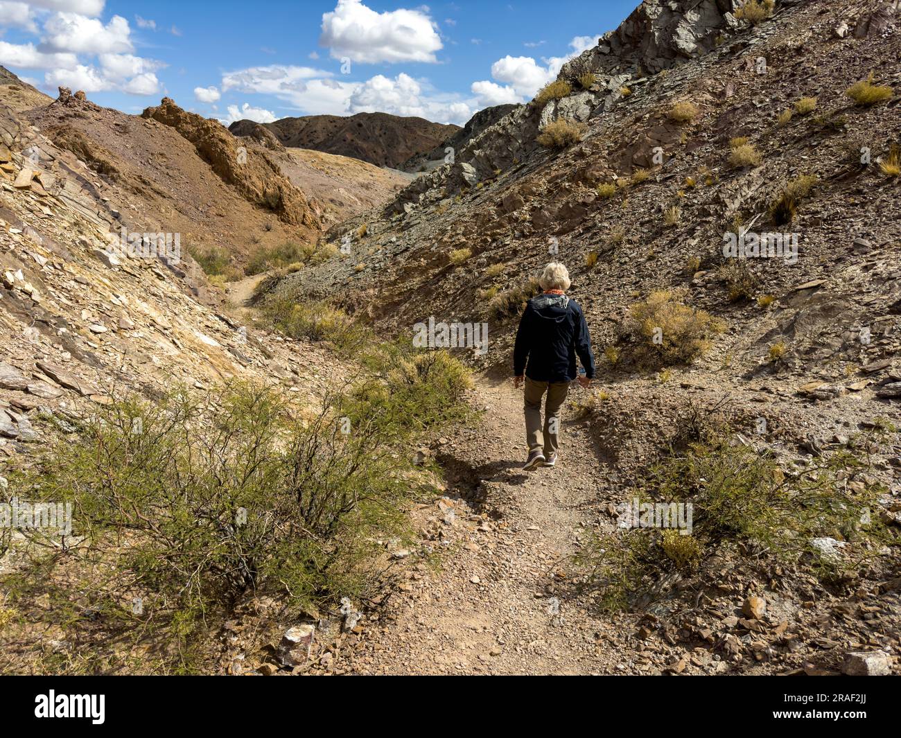 A hiker on the Sendero Paisajes del Agua in El Leoncito National Park ...