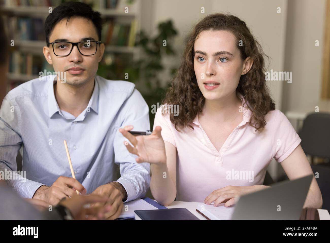 Couple of college students cooperating on class project with team Stock ...