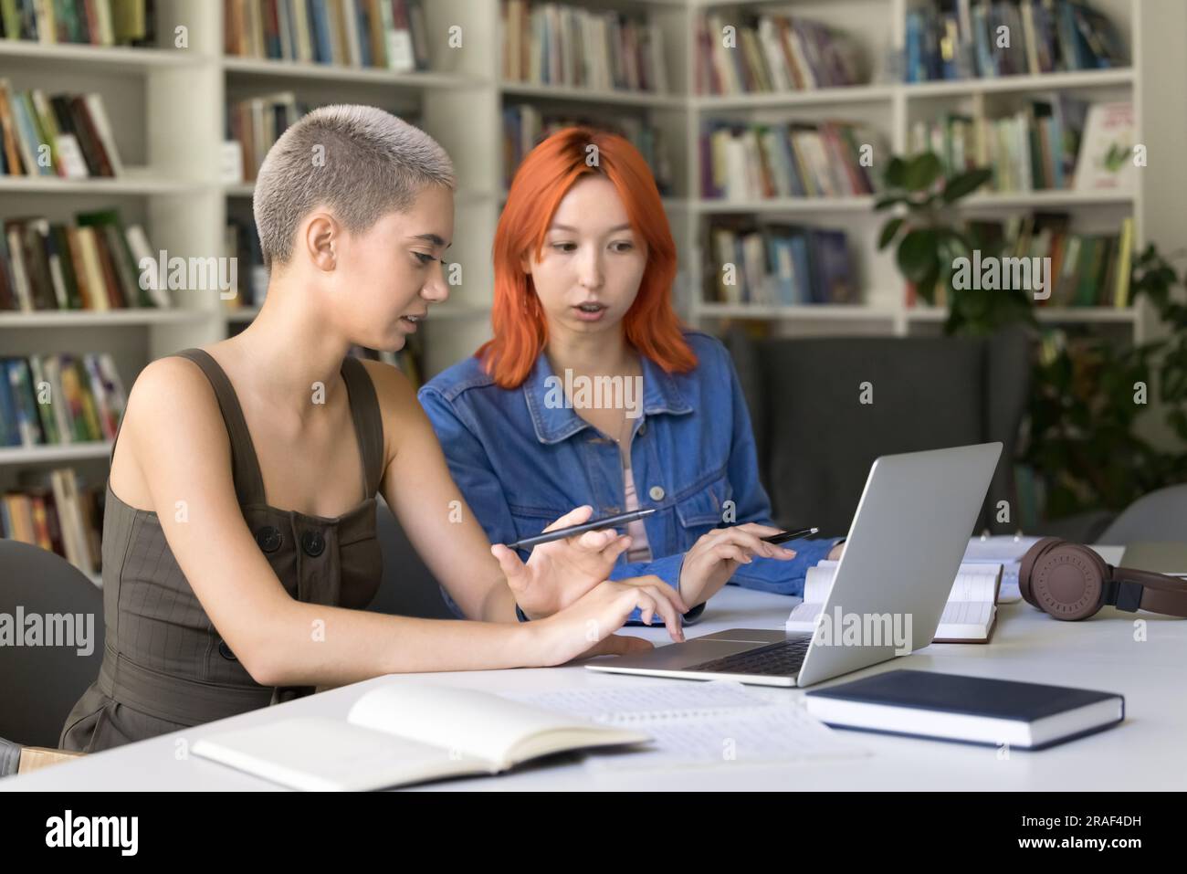 Focused high school friends cooperating on class project together Stock ...