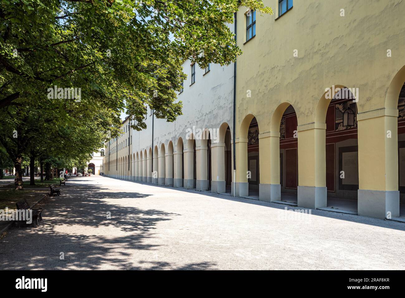 Promenade with long arcade columns surrounding Hofgarten Park in Munich ...