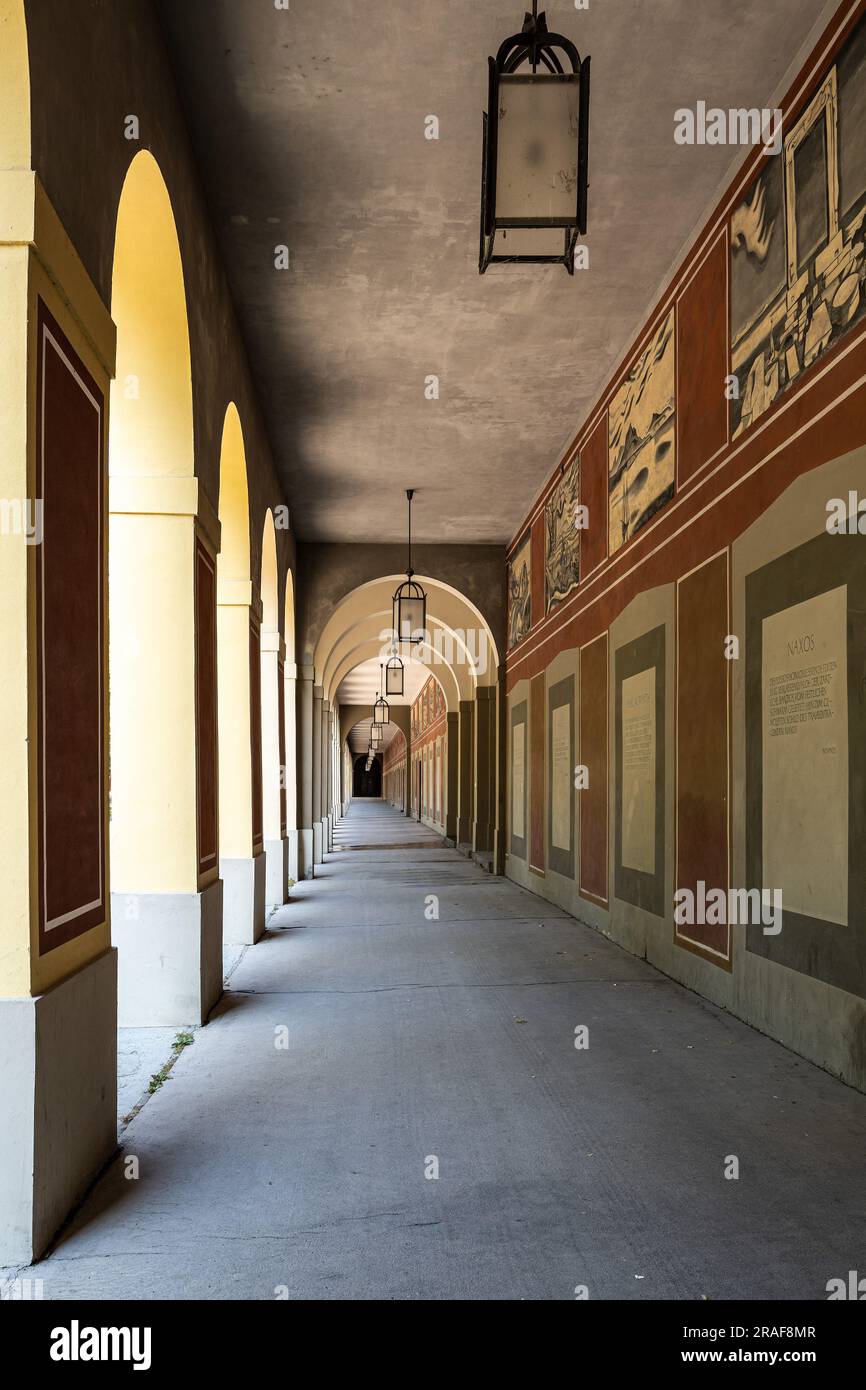 Promenade with long arcade columns surrounding Hofgarten Park in Munich ...