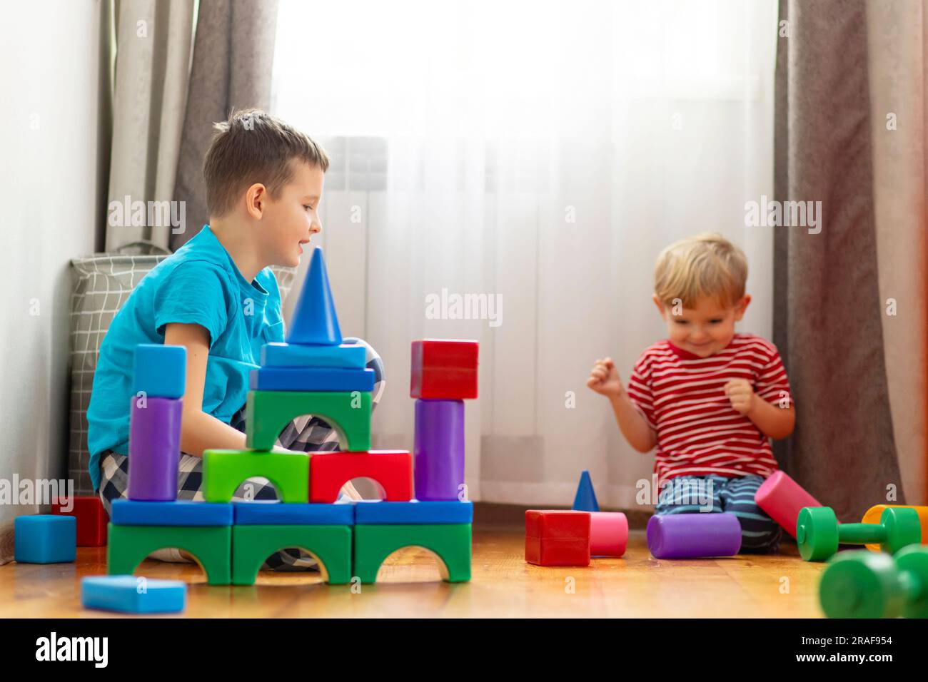 Kids are playing with children building blocks on floor Stock Photo - Alamy