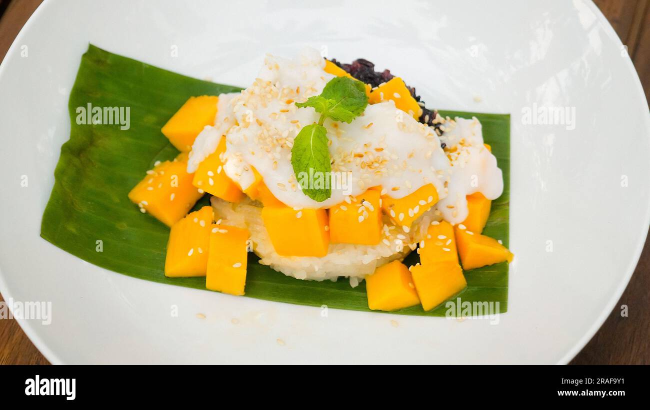 Traditional flavors of Thailand with a mango sticky rice Stock Photo ...