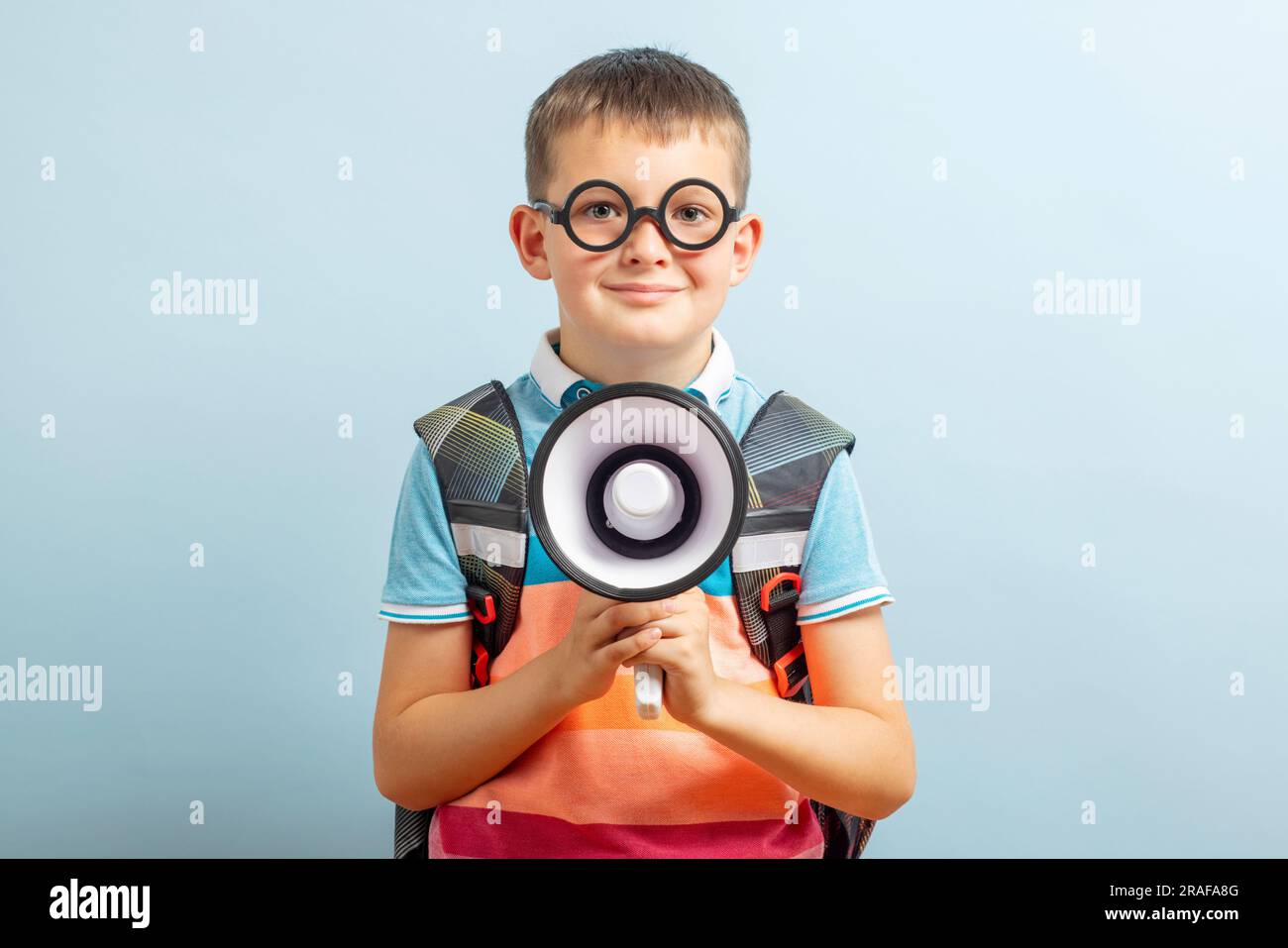 Little schoolboy with megaphone on blue background. Boy with megaphone ...