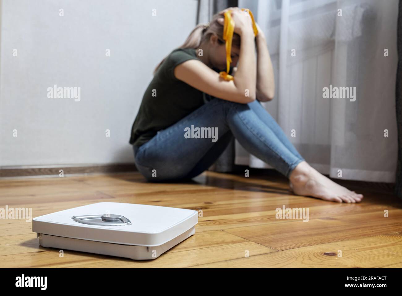 Scale and depression, upset and sad woman with measuring tape on wooden ...