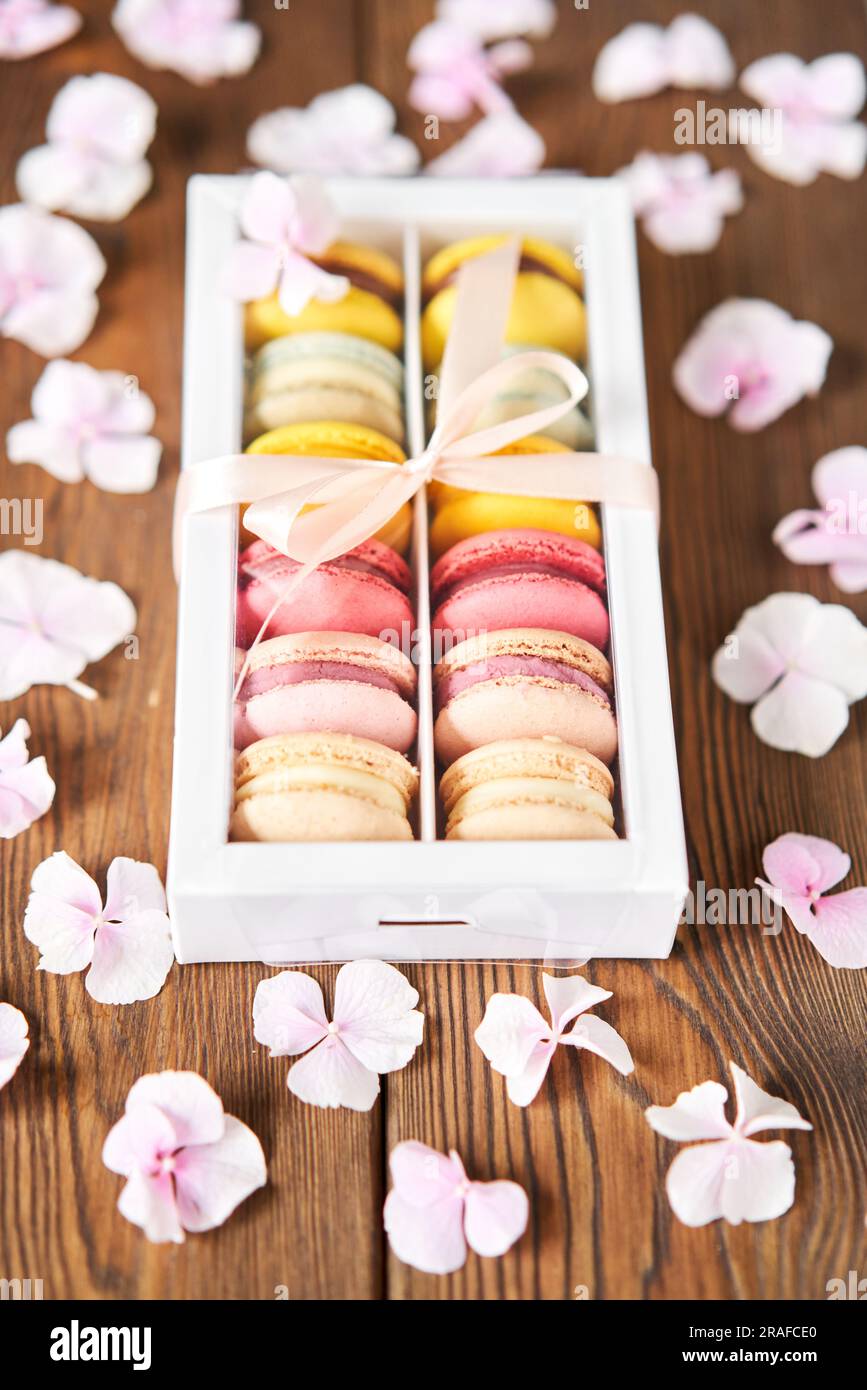 Dessert French Macarons in present box. Sweet dessert on a flowers ...