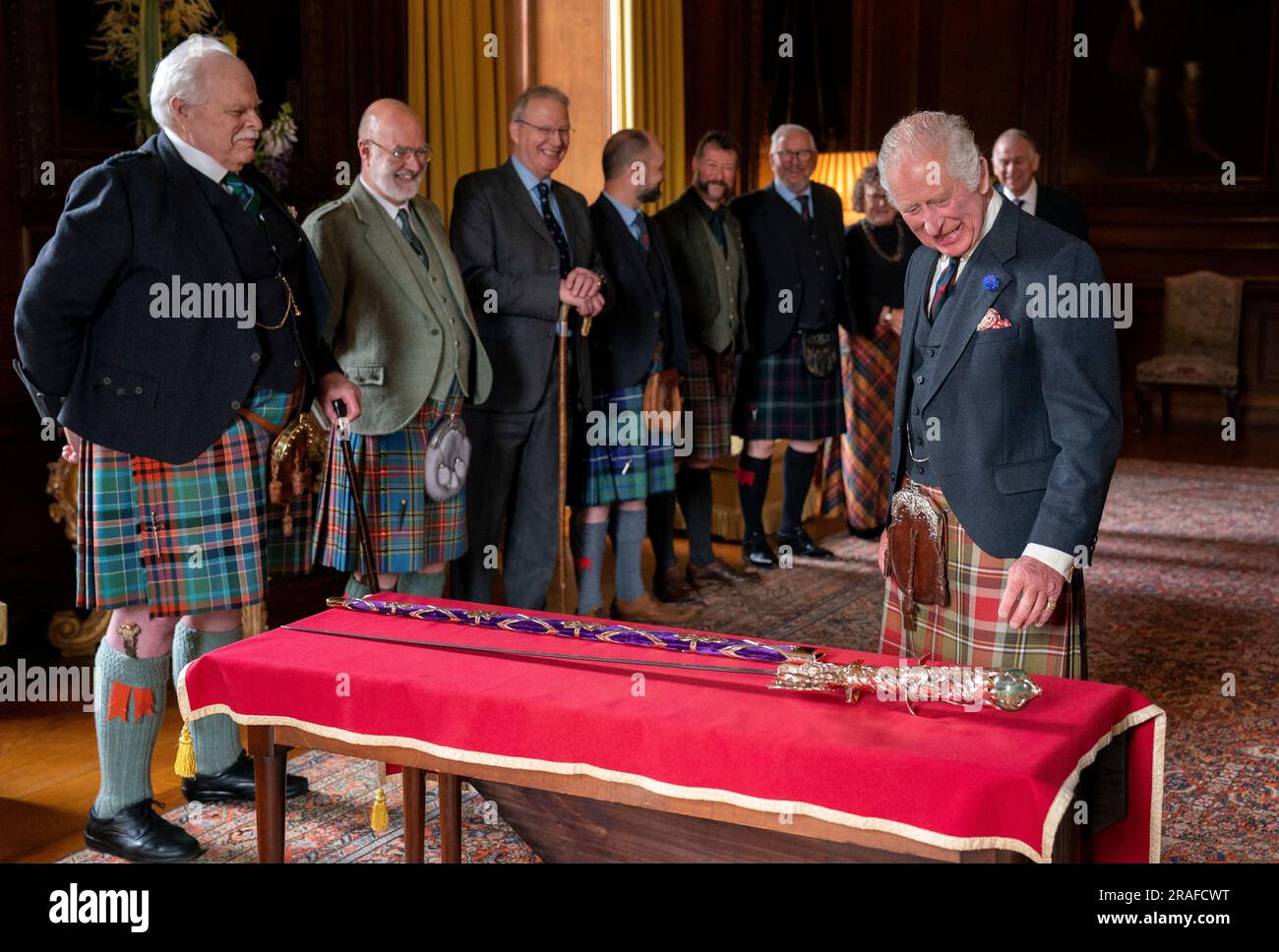 King Charles III with designer Mark Dennis (left) and the new Elizabeth ...