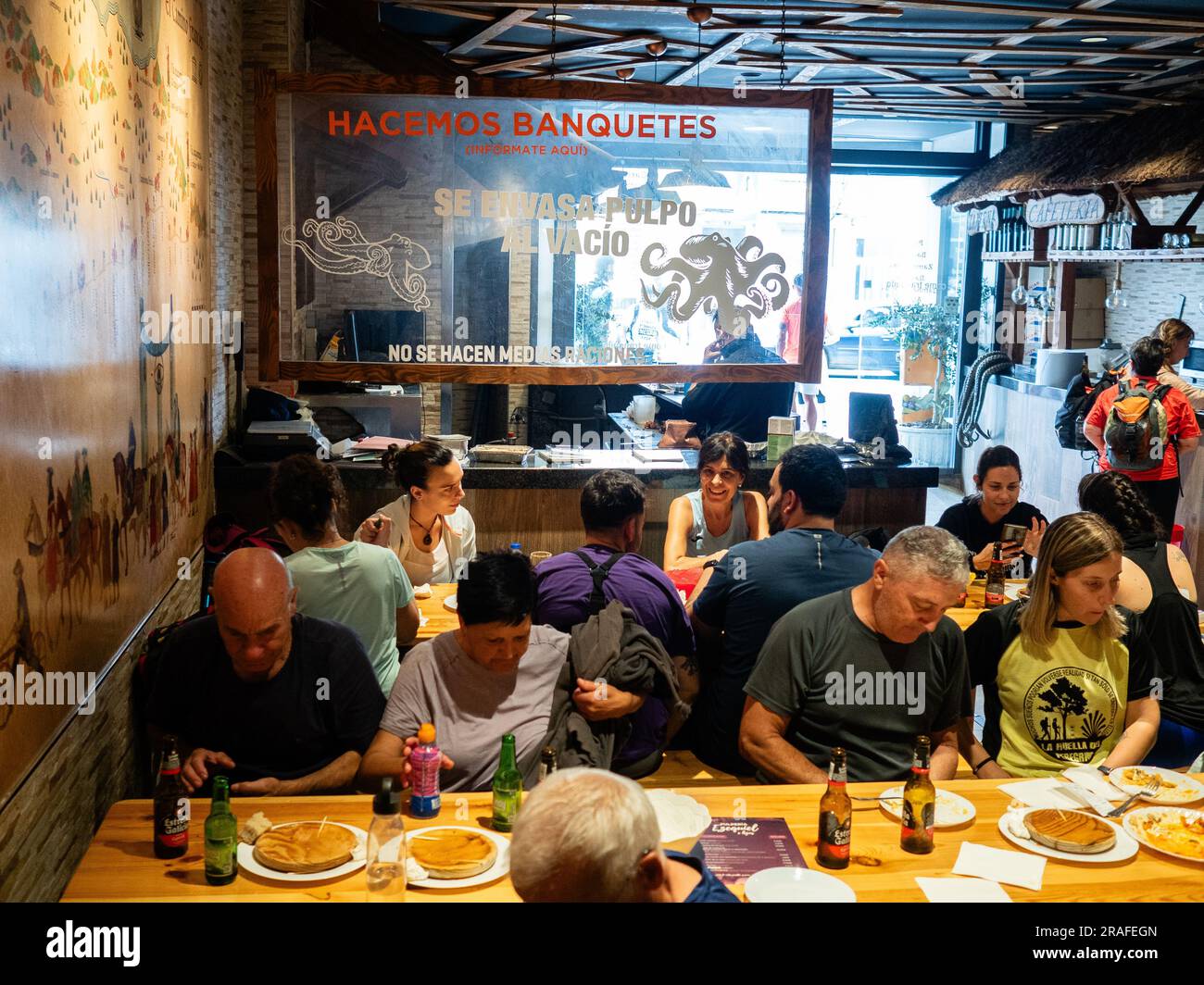 Melide, Spain. 31st May, 2023. Pilgrims are seen eating octopus in one ...