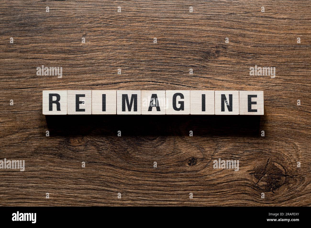 Reimagine - word concept on building blocks, text Stock Photo - Alamy