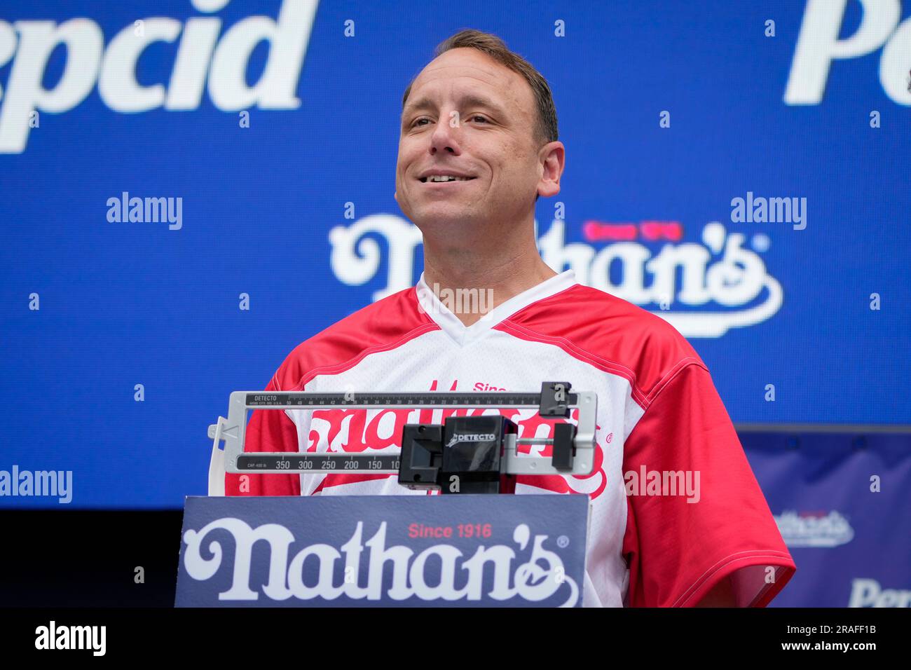 Competitive eater Joey Chestnut steps on the scale during a weigh-in ...